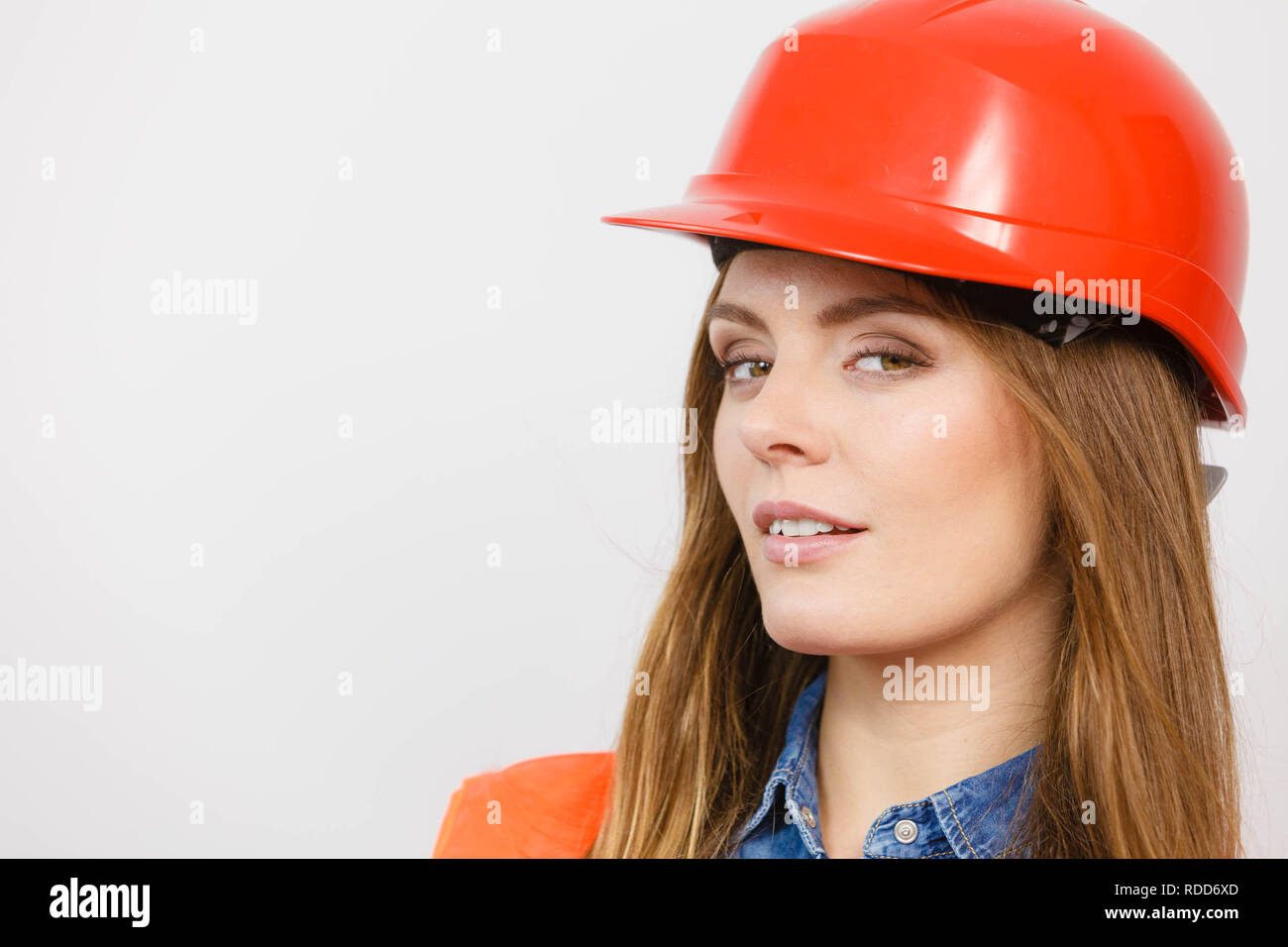 Woman construction worker builder structural engineerin in red hard ...