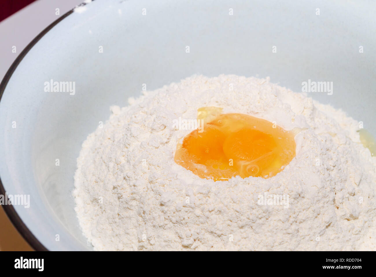 The egg is divided into white flour in the bowl Stock Photo - Alamy