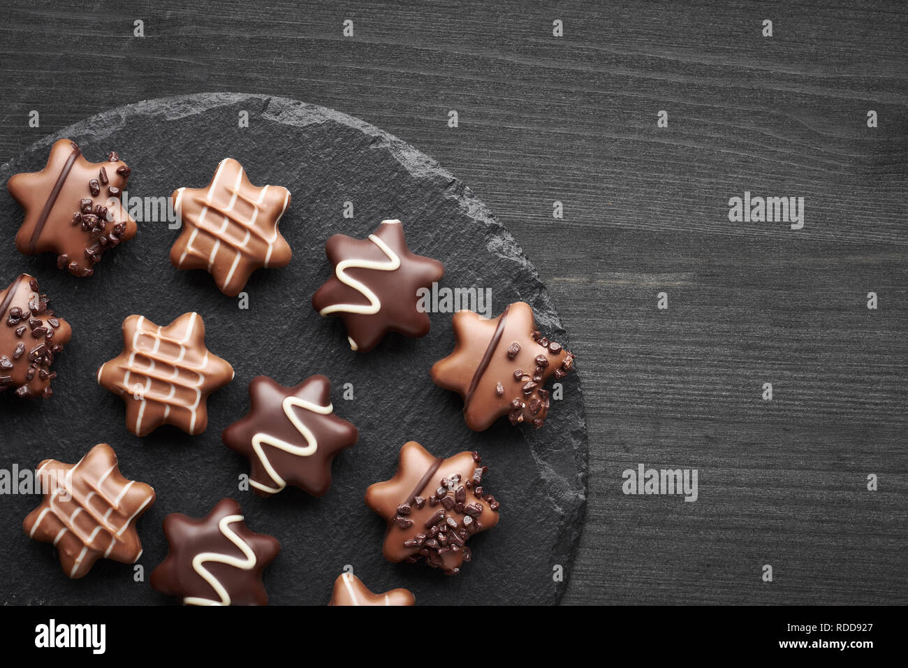 Star-shaped chocolates on dark textured background with text space ...