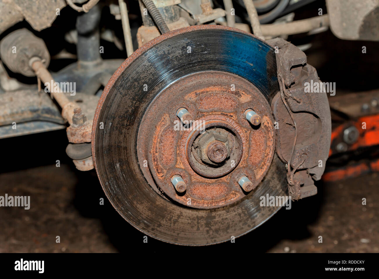 A car with the front wheel removed where you can see the brake disc ...