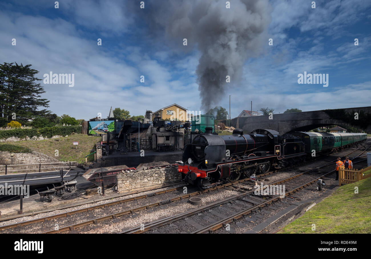 Steam locomotive passing under a bridge near the train station, Swanage ...