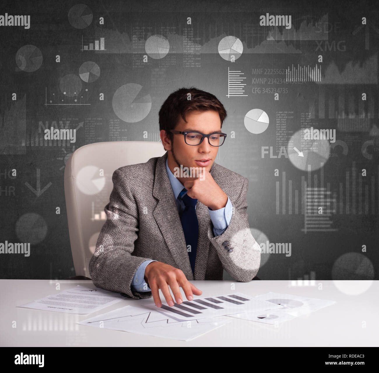 Young manager at the office making report and statistics with ...