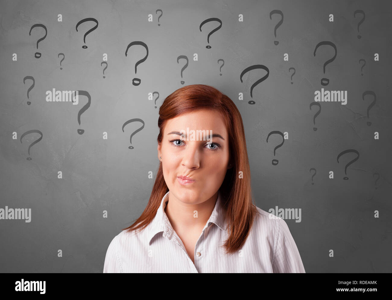 Person with question marks around face Stock Photo - Alamy