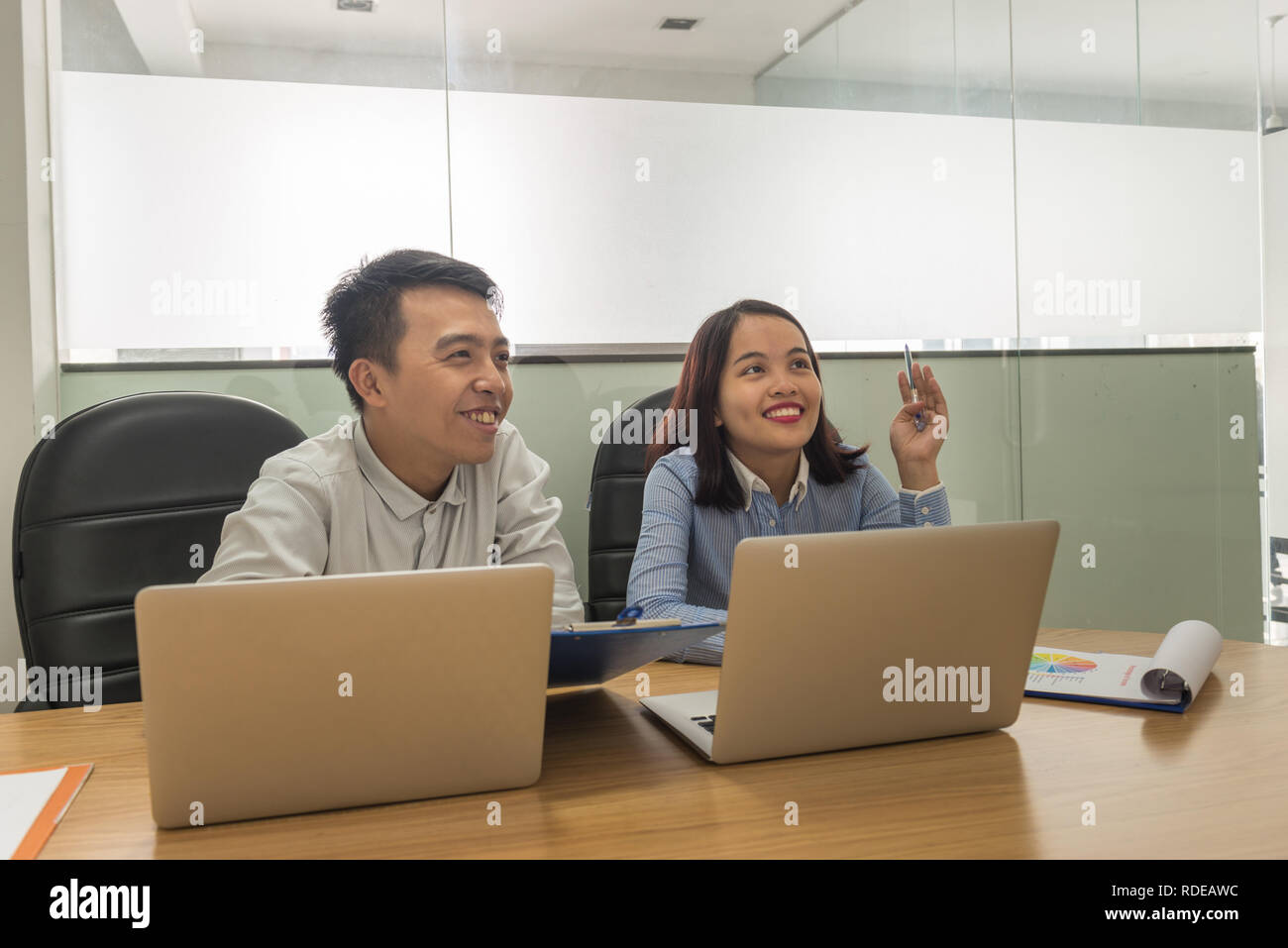 Business team sharing ideas and discussing to each other in meeting ...