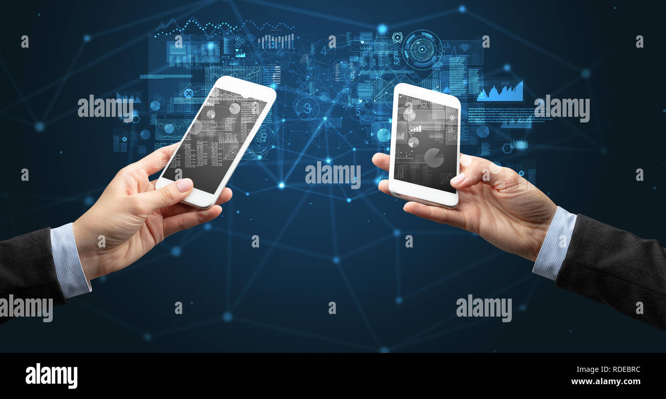 Close up of two hands holding smartphones to sync business data Stock ...