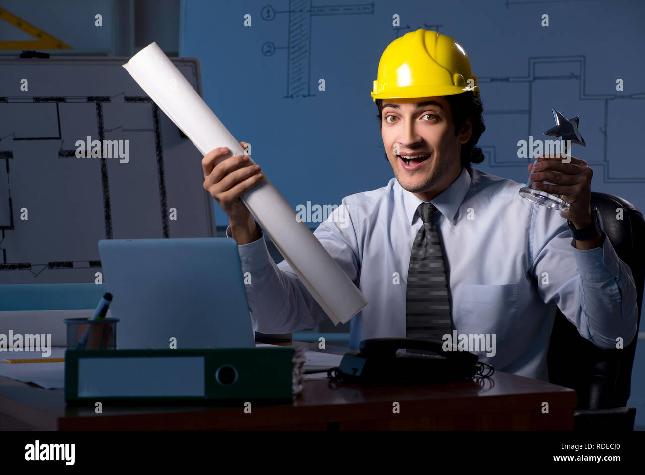 Young construction architect working on project at night Stock Photo ...