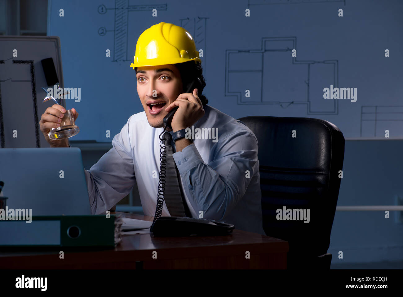Young construction architect working on project at night Stock Photo ...