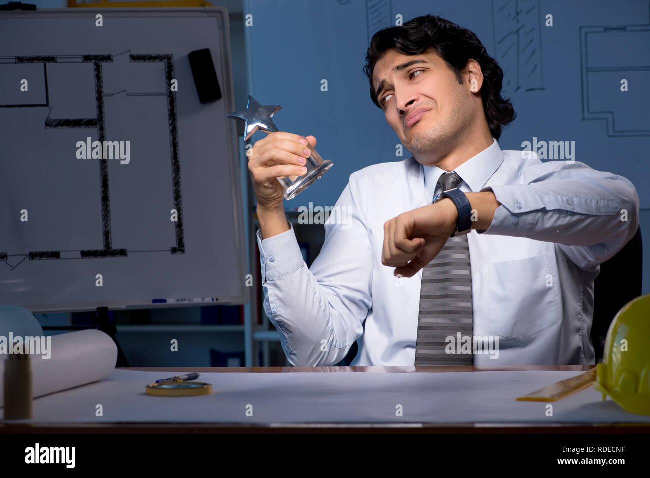 Young construction architect working on project at night Stock Photo ...