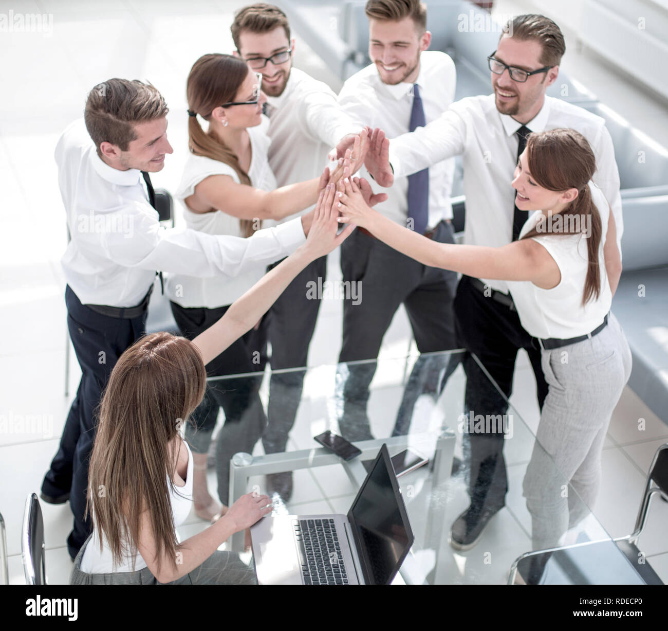 happy business team putting their hands together Stock Photo - Alamy