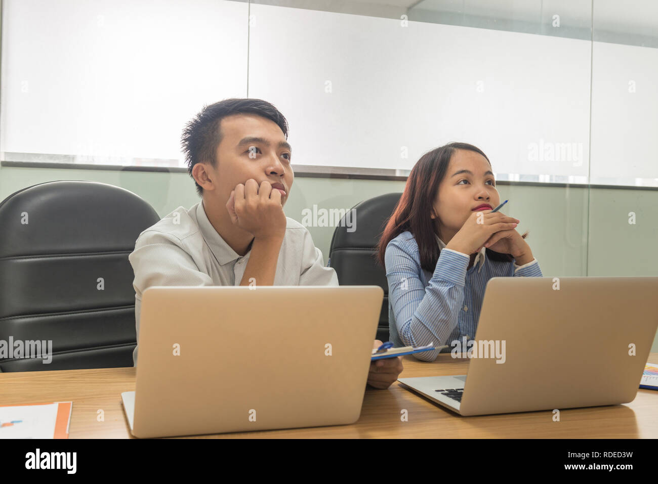 Young Asian employees carefully listening in meeting Stock Photo - Alamy