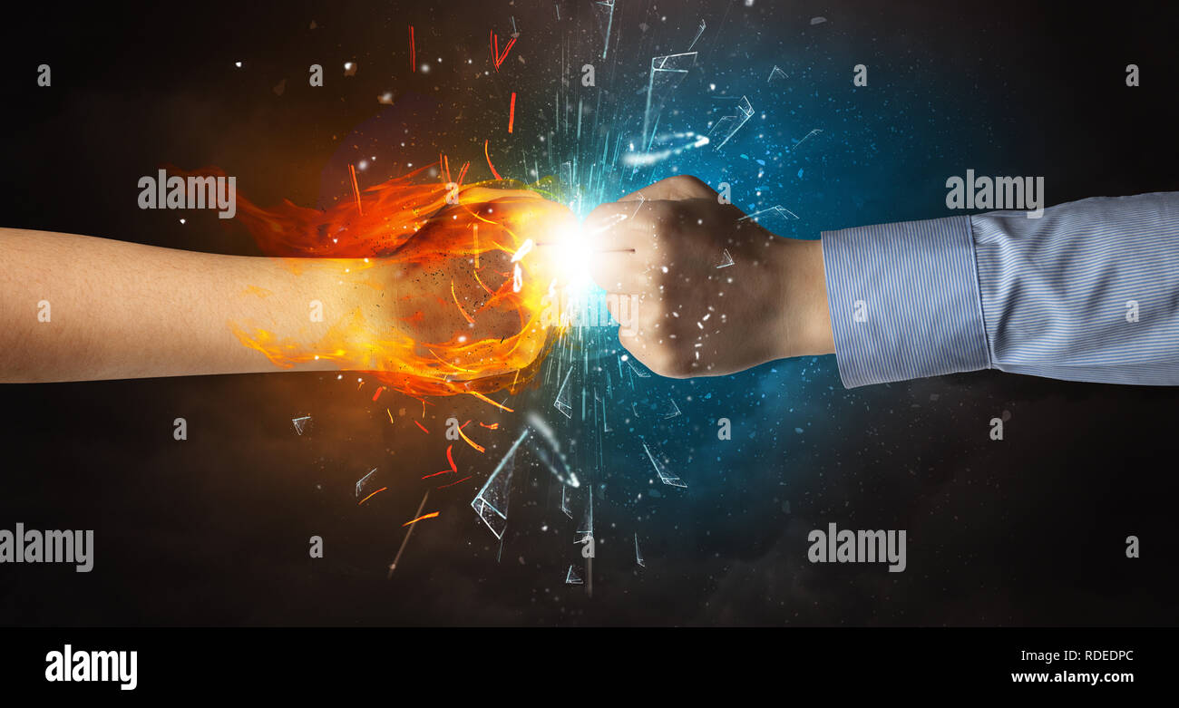 Two hands fighting and breaking glass into small pieces with fire and ...