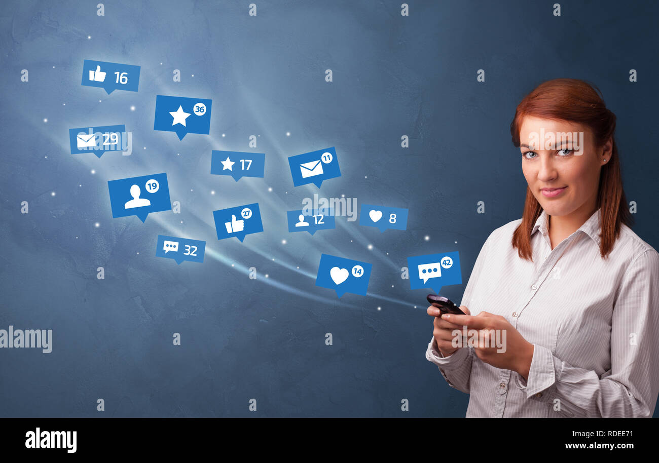 Young person using phone with flying social media icons around Stock ...