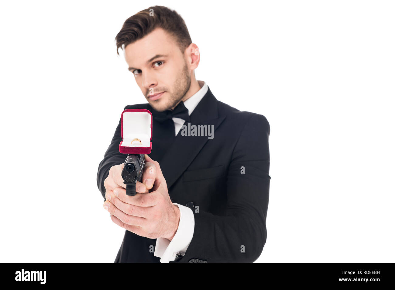 handsome secret agent in black suit aiming with handgun with proposal ...