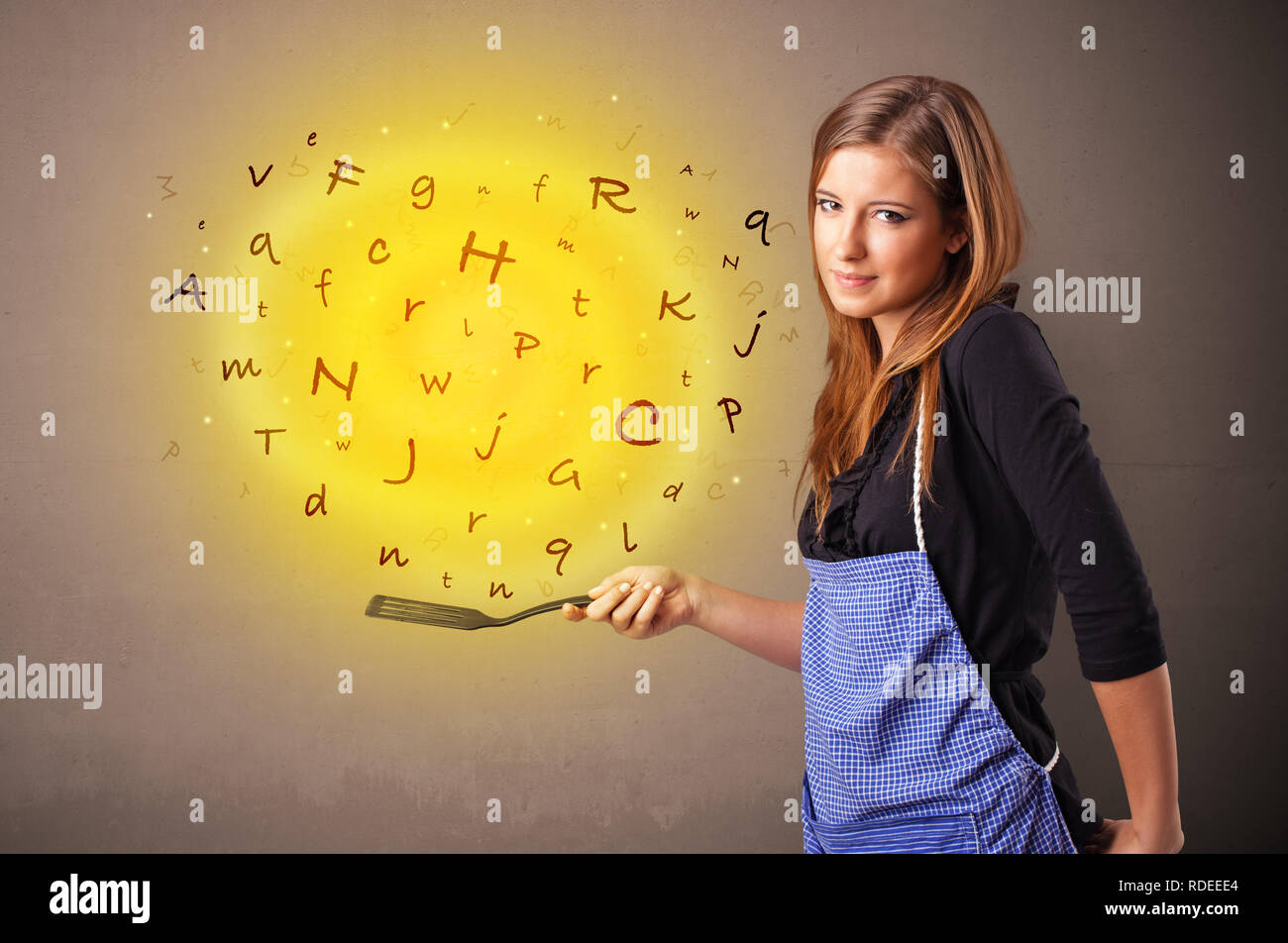 Young person cooking letters in wok Stock Photo - Alamy