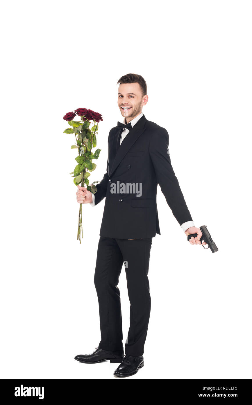 smiling secret agent in black suit holding handgun and red roses ...