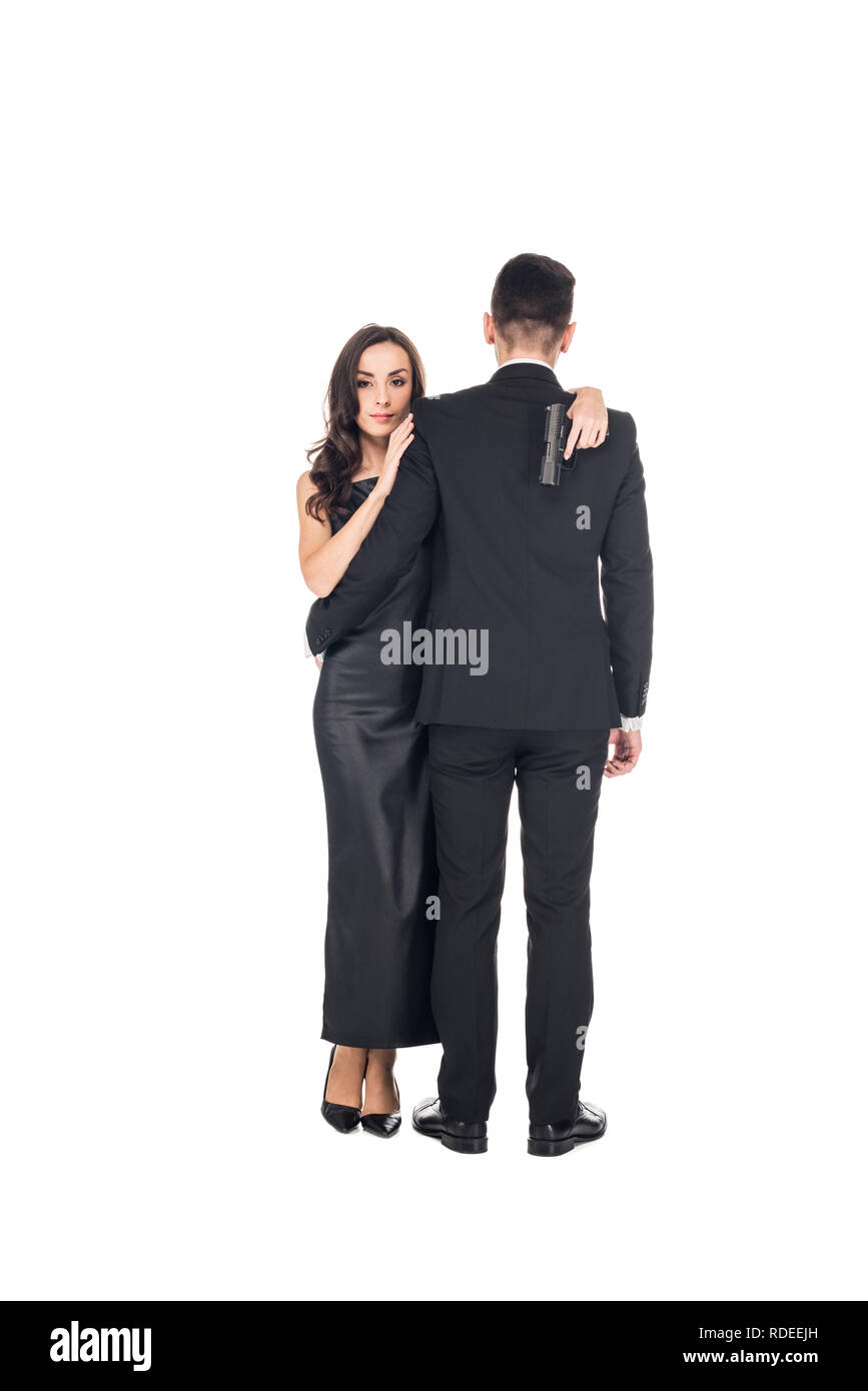 elegant couple of secret agents hugging and holding gun, isolated on ...