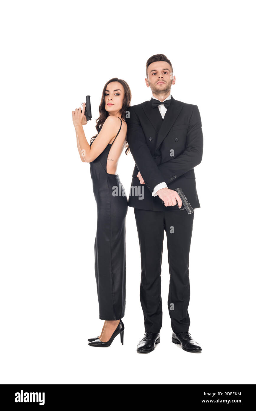 elegant couple of secret agents in black clothes posing with guns ...