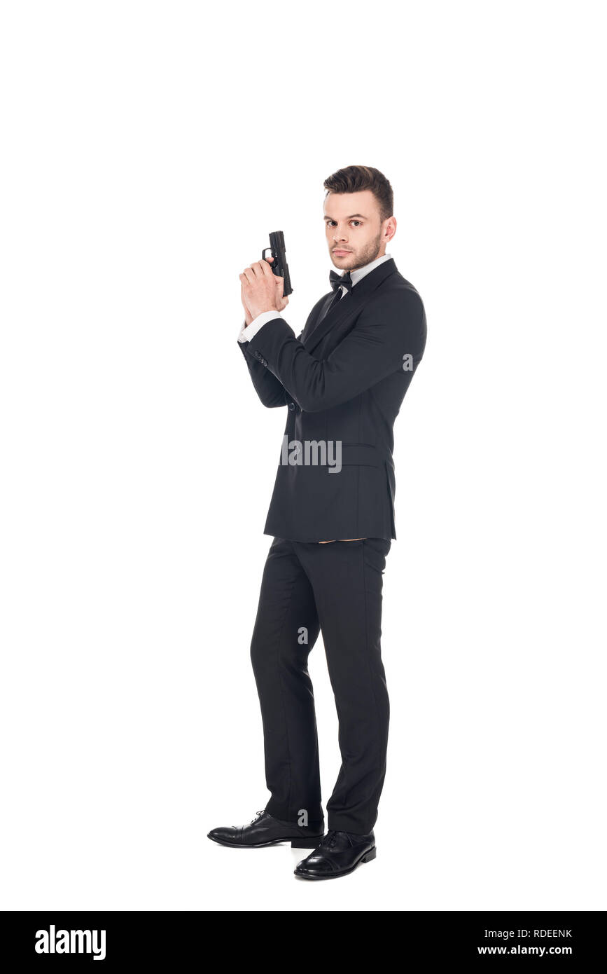 elegant secret agent in black suit holding gun, isolated on white Stock ...