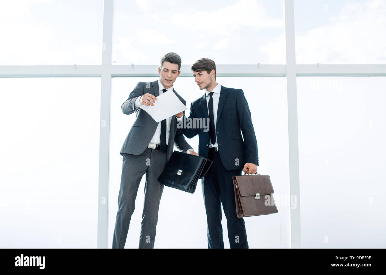 business people with leather briefcases standing near the office Stock ...