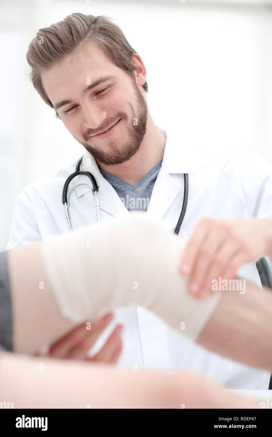 traumatologist examining the bandage on his knee Stock Photo - Alamy