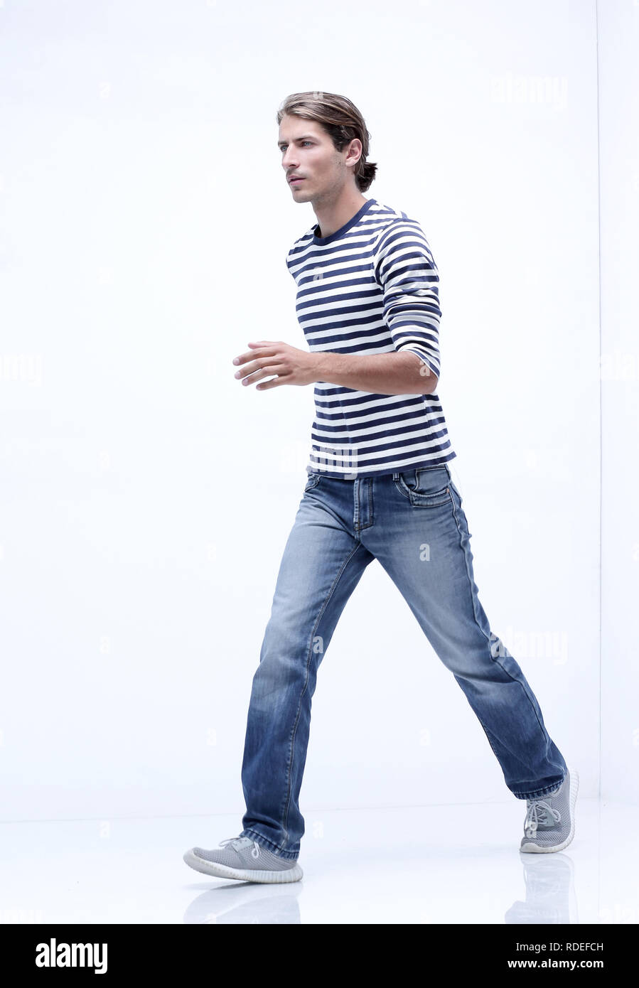 Side view.strong young man goes forward Stock Photo - Alamy