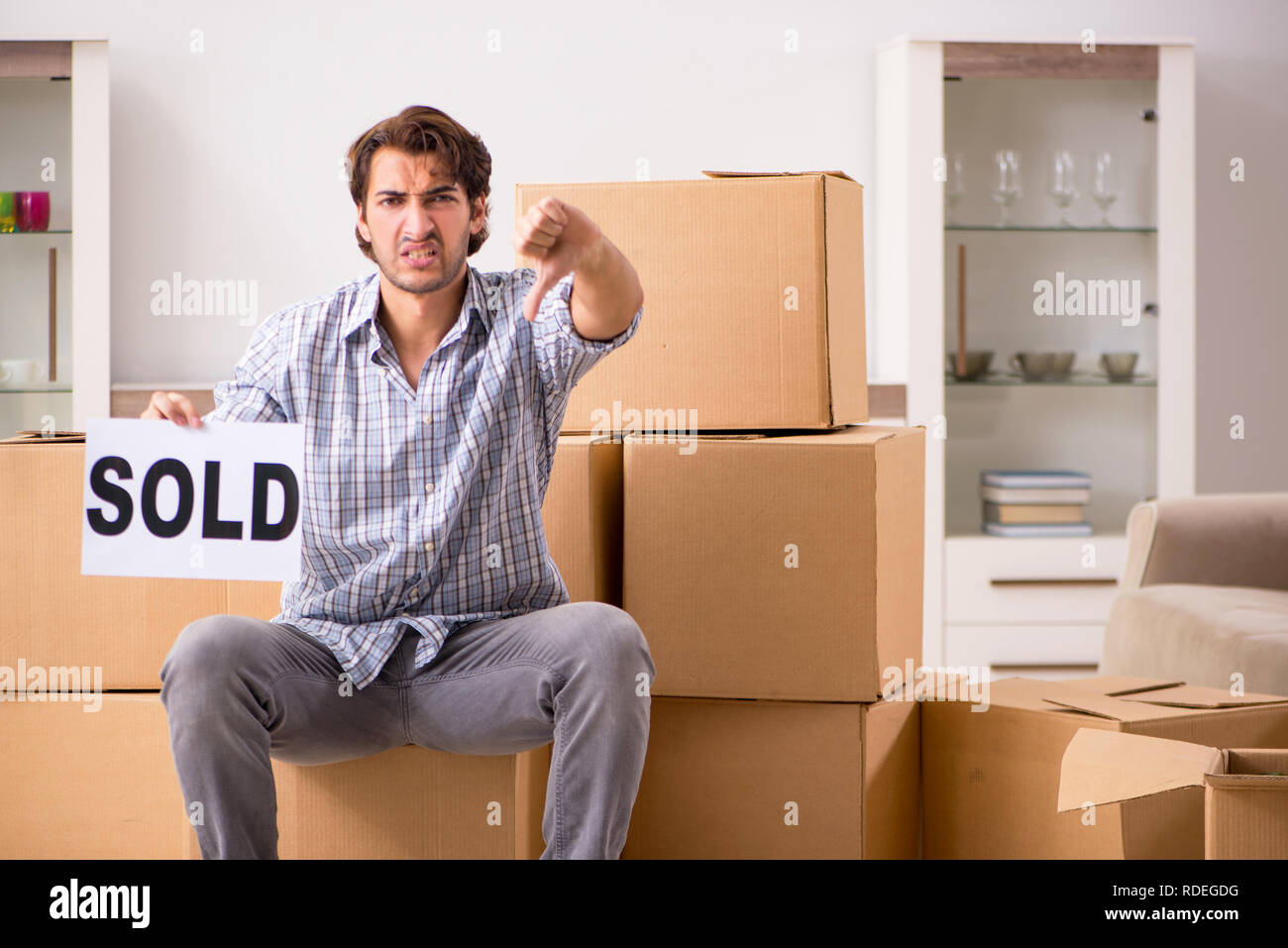 Young man selling his house Stock Photo - Alamy