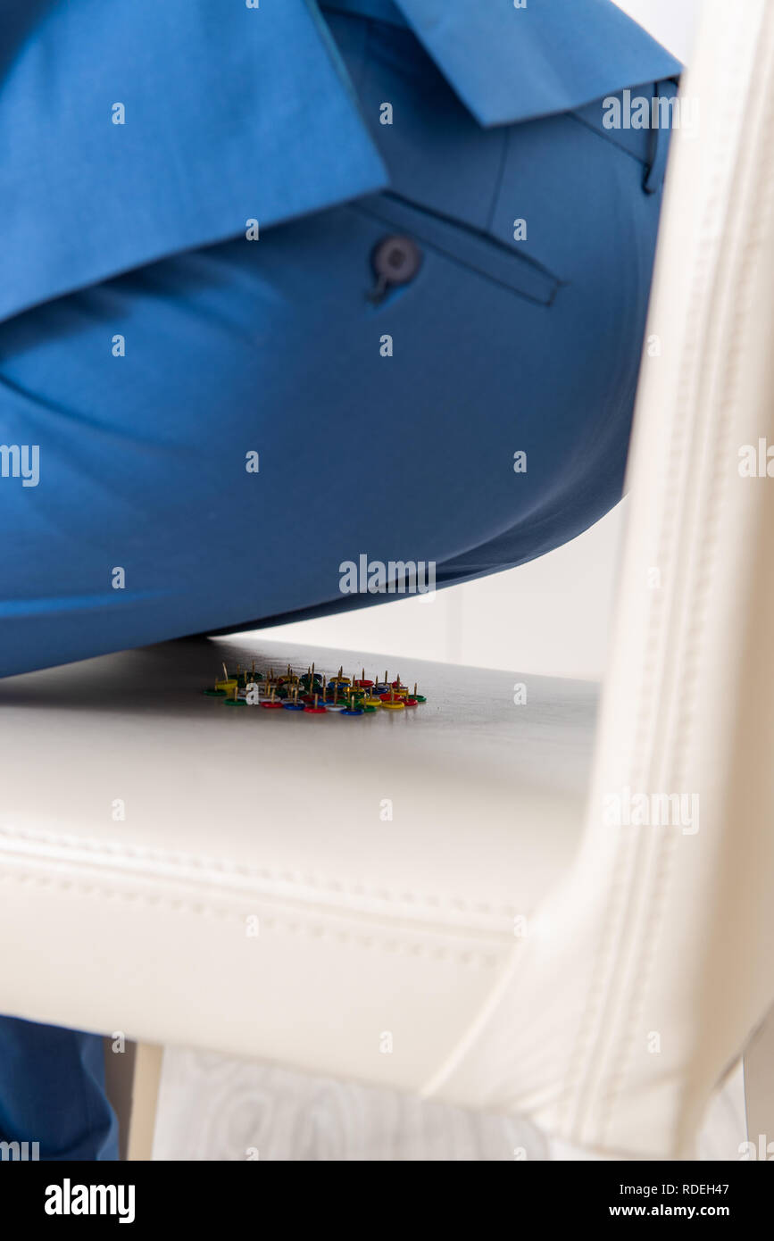 Office prank with sharp thumbtacks on chair Stock Photo - Alamy