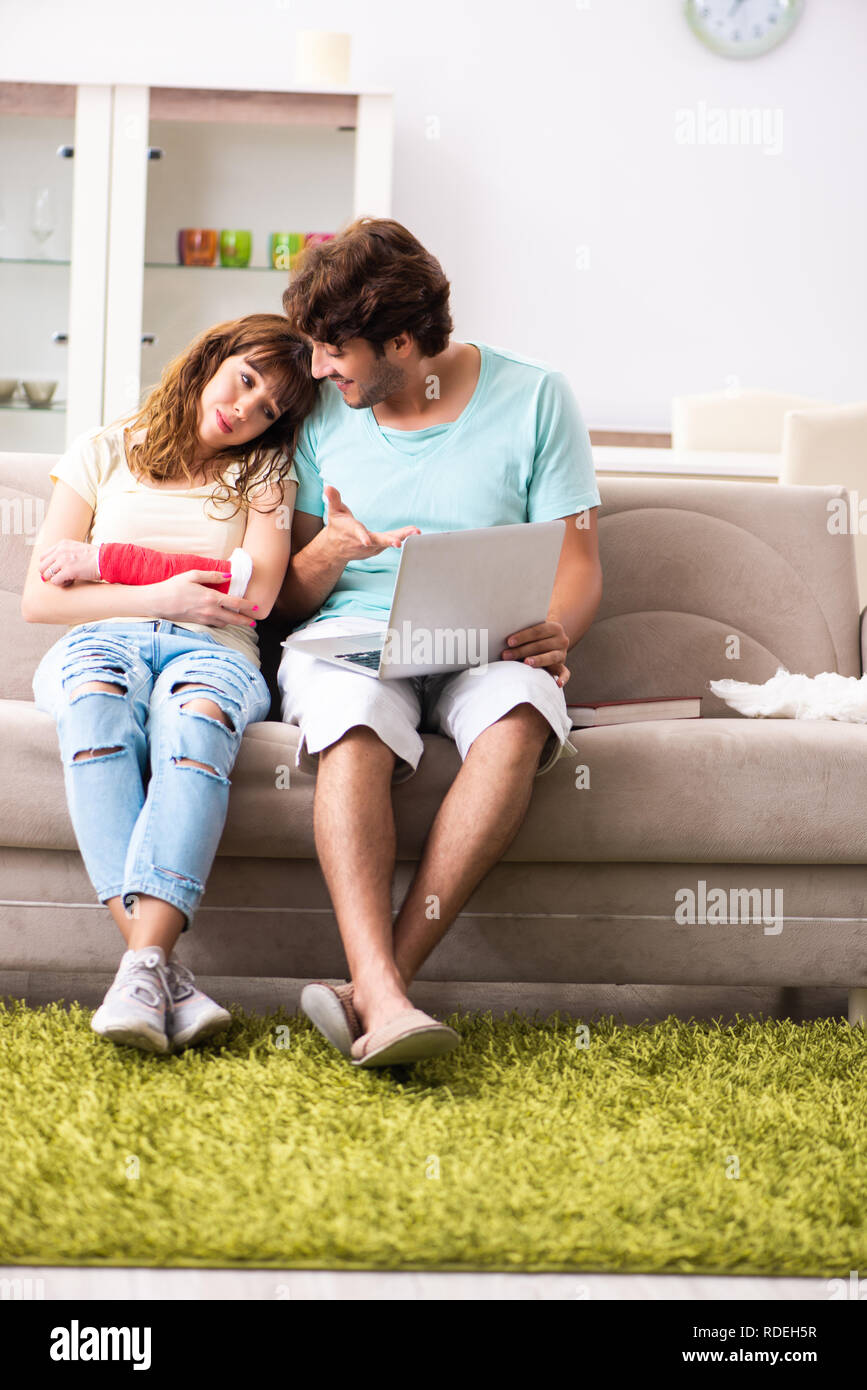 Young family helping each other after injury Stock Photo - Alamy