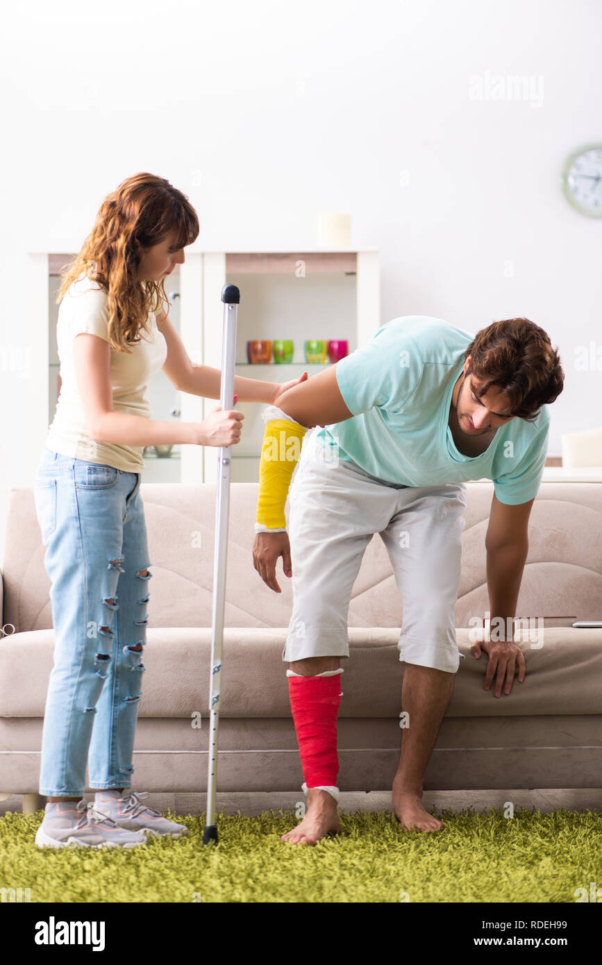 Young family helping each other after injury Stock Photo - Alamy