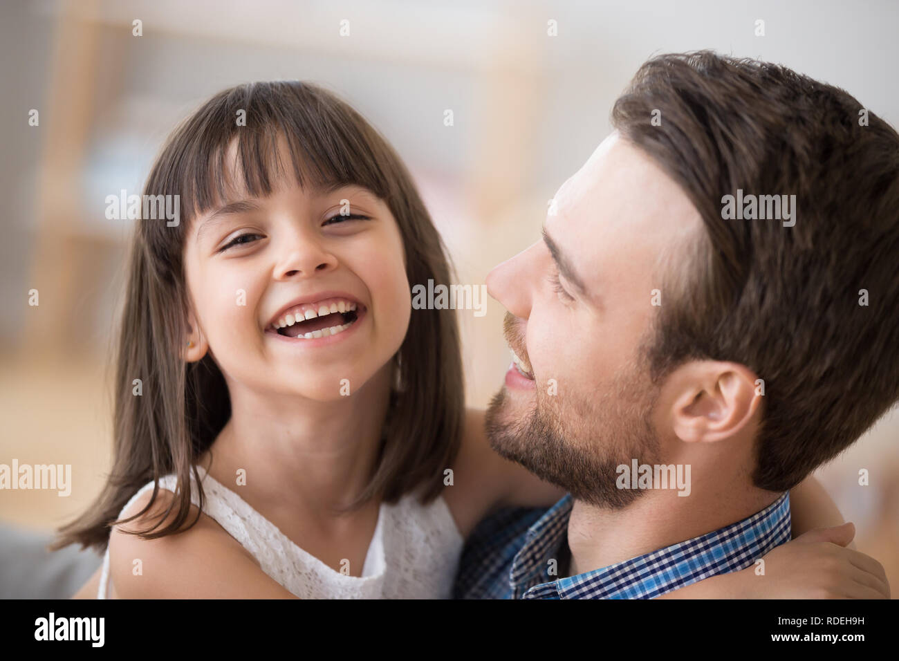 Adorable kid girl laughing looking at camera embracing happy fat Stock ...