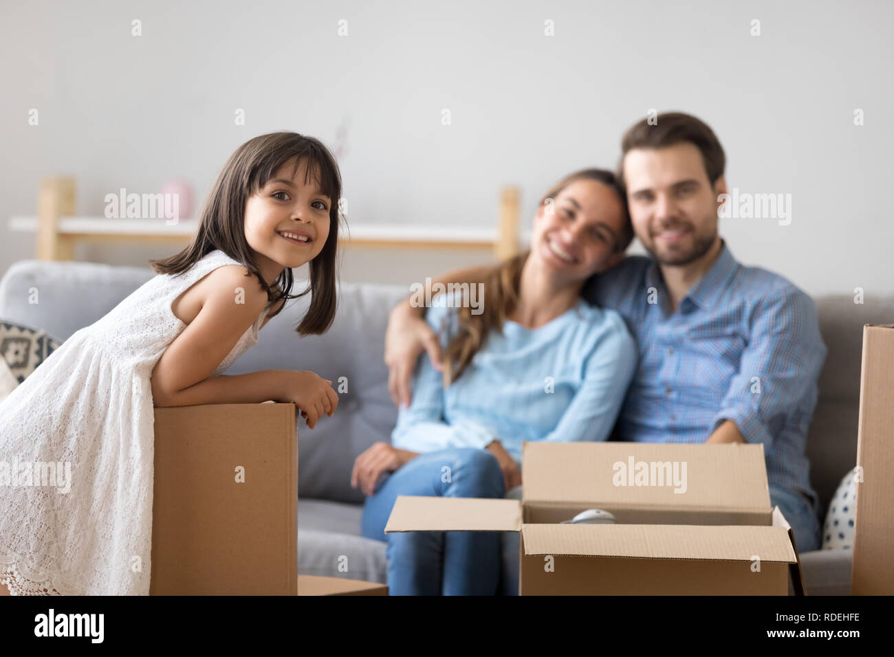 Portrait of happy kid posing with boxes on moving day Stock Photo - Alamy