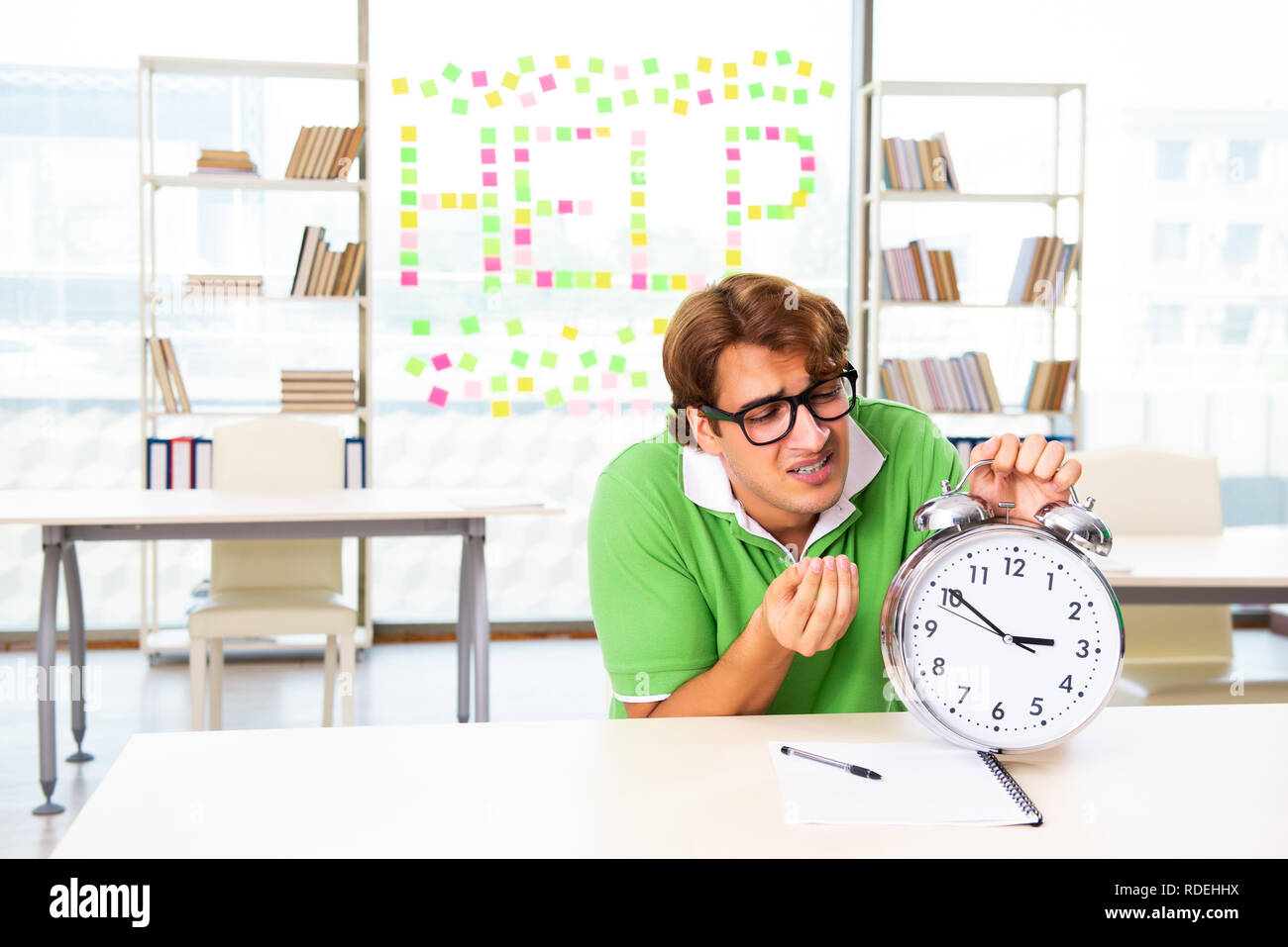 Student struggling at the exam in classroom Stock Photo - Alamy