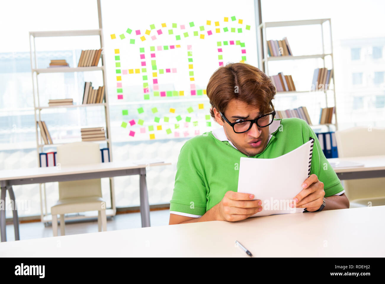 Student struggling at the exam in classroom Stock Photo - Alamy