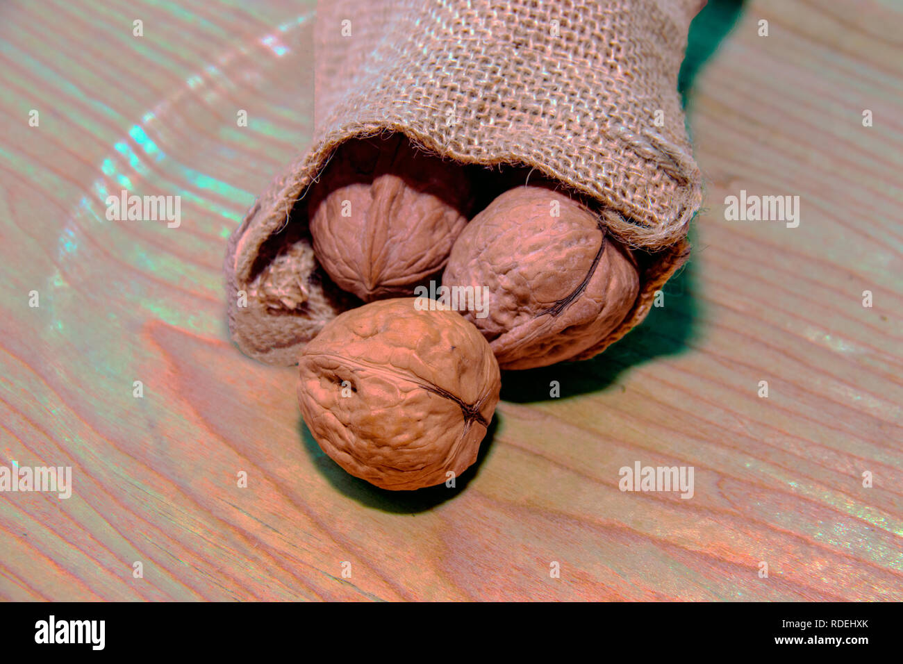 whole nuts with a sack with wooden background Stock Photo - Alamy
