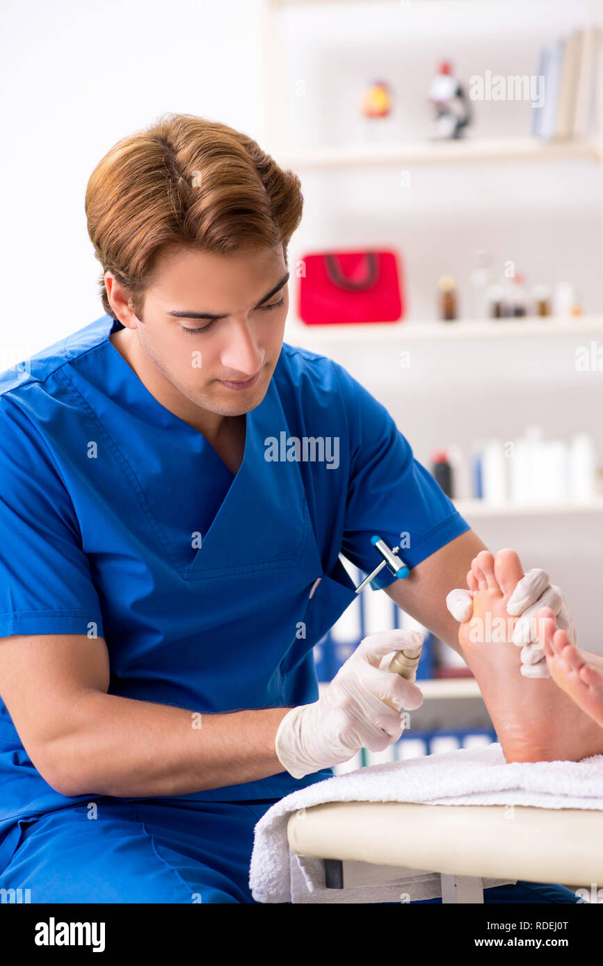 Podiatrist treating feet during procedure Stock Photo - Alamy