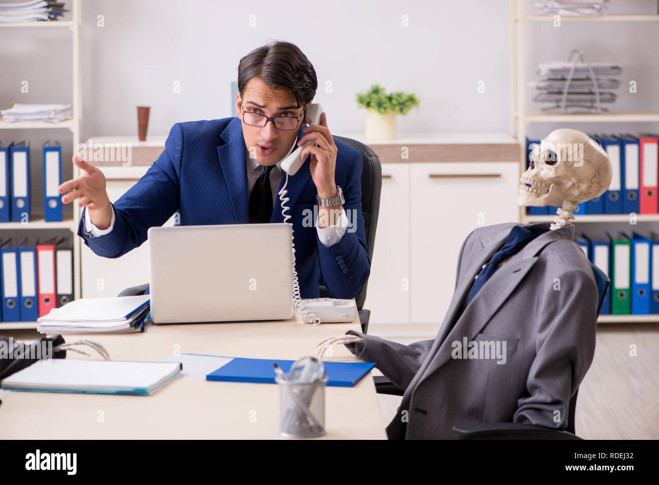 Funny business meeting with boss and skeletons Stock Photo - Alamy