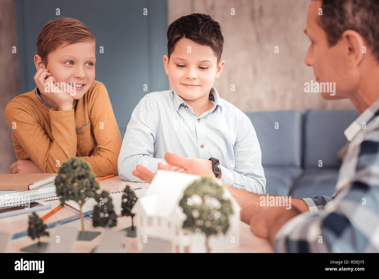 Two smart curious boys listening attentively to their uncle Stock Photo ...