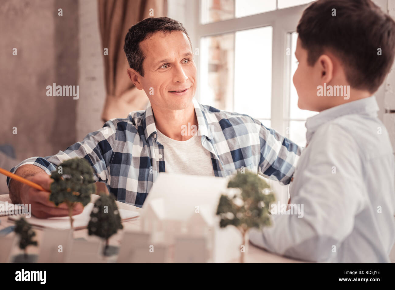 Blue-eyed foster father listening to his adopted kid Stock Photo - Alamy