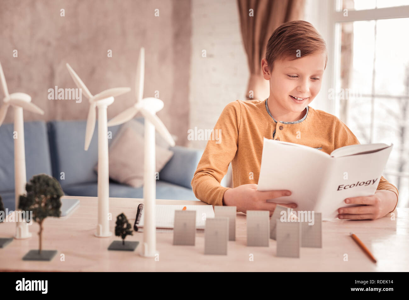 Smart blonde-haired schoolboy holding his exercise book Stock Photo - Alamy