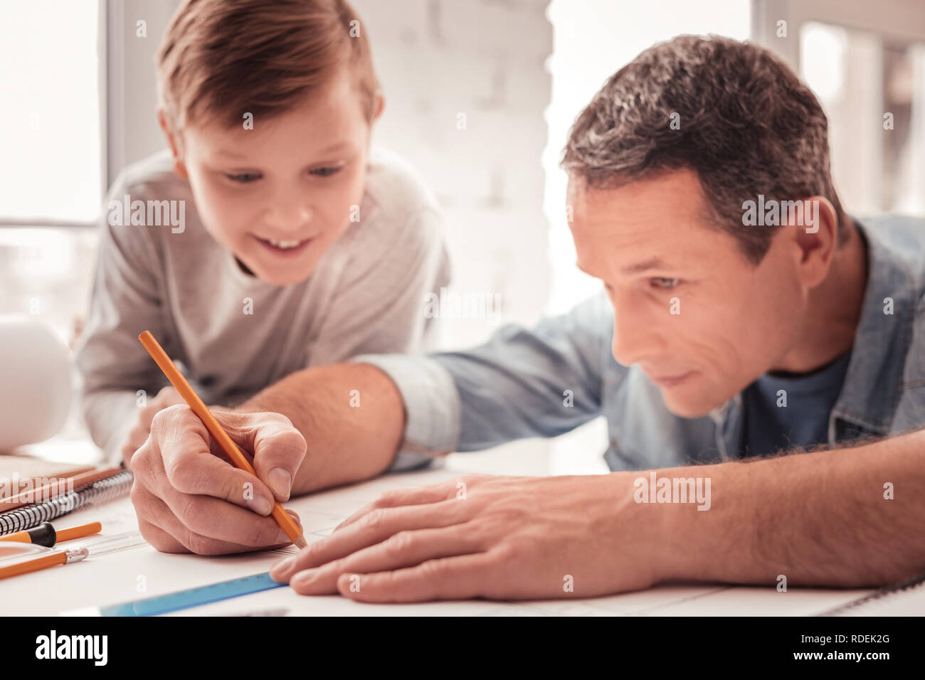 Father helping his son drawing geometrical figures Stock Photo - Alamy
