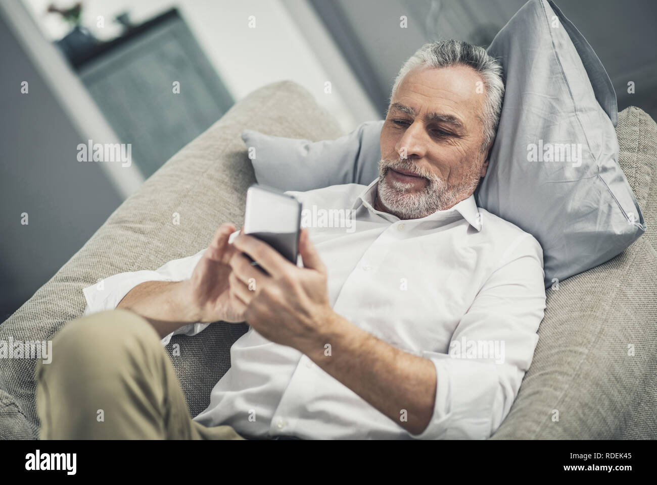 Tired exhausted businessman lying on sofa Stock Photo - Alamy
