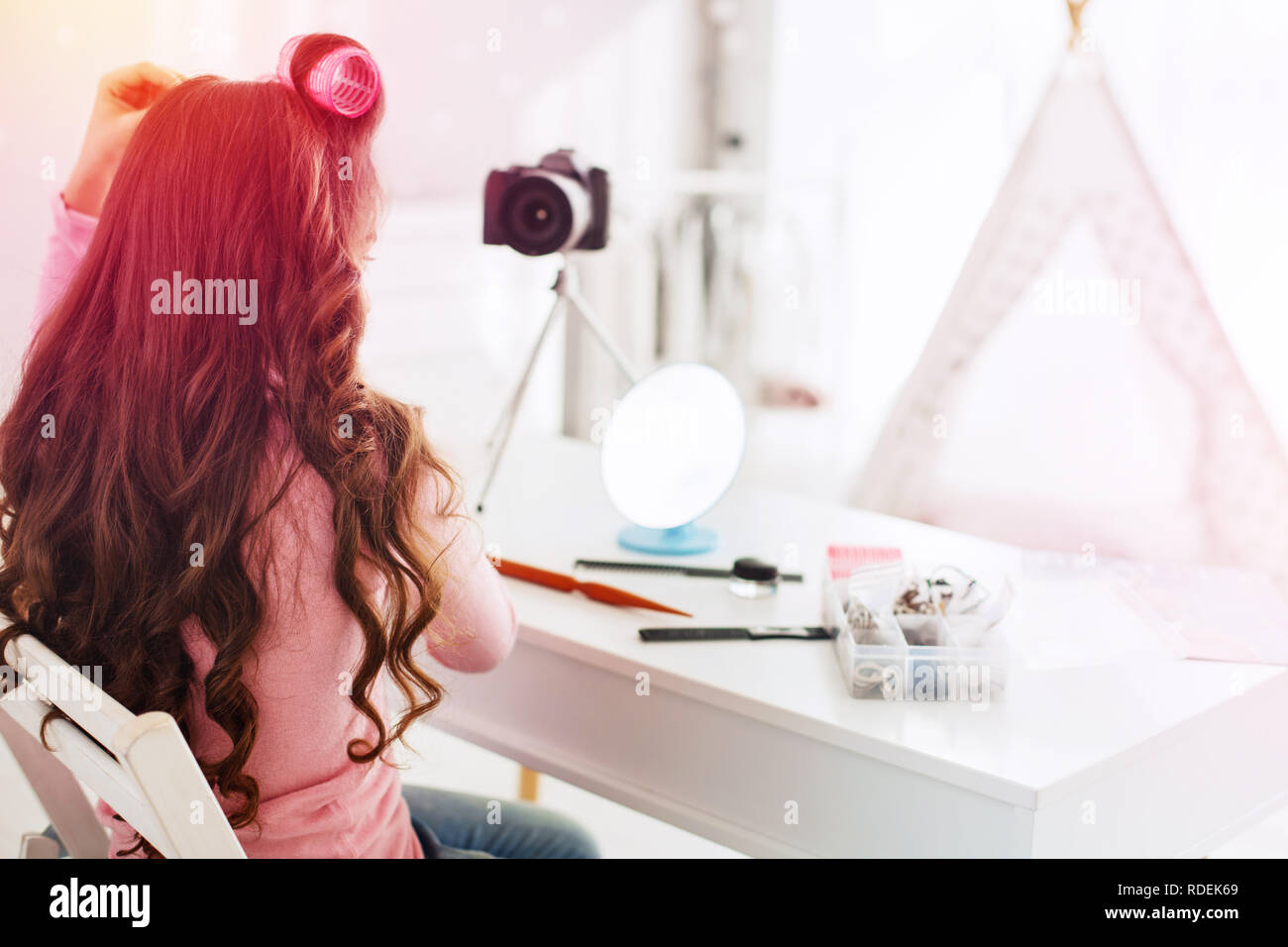 Young beauty blogger sitting in front of camera while making nice ...