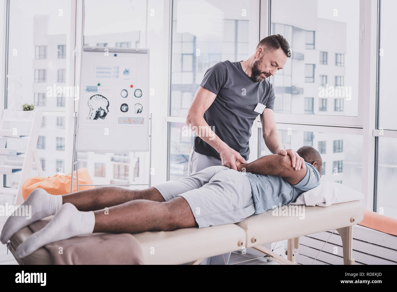 Professional doctor doing rehabilitation exercises with patient Stock ...