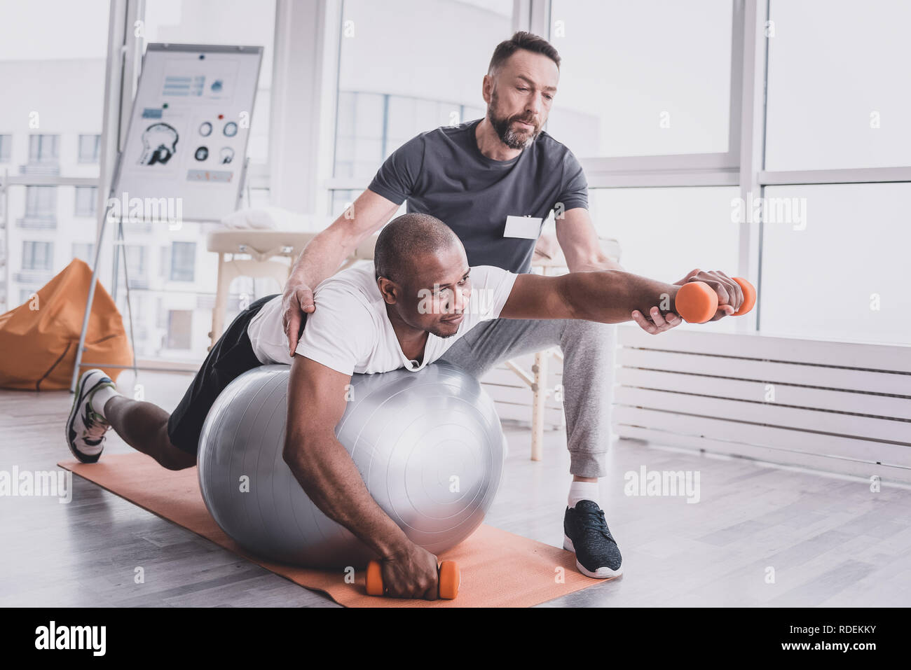 Serious practitioner supporting his patient during train Stock Photo ...