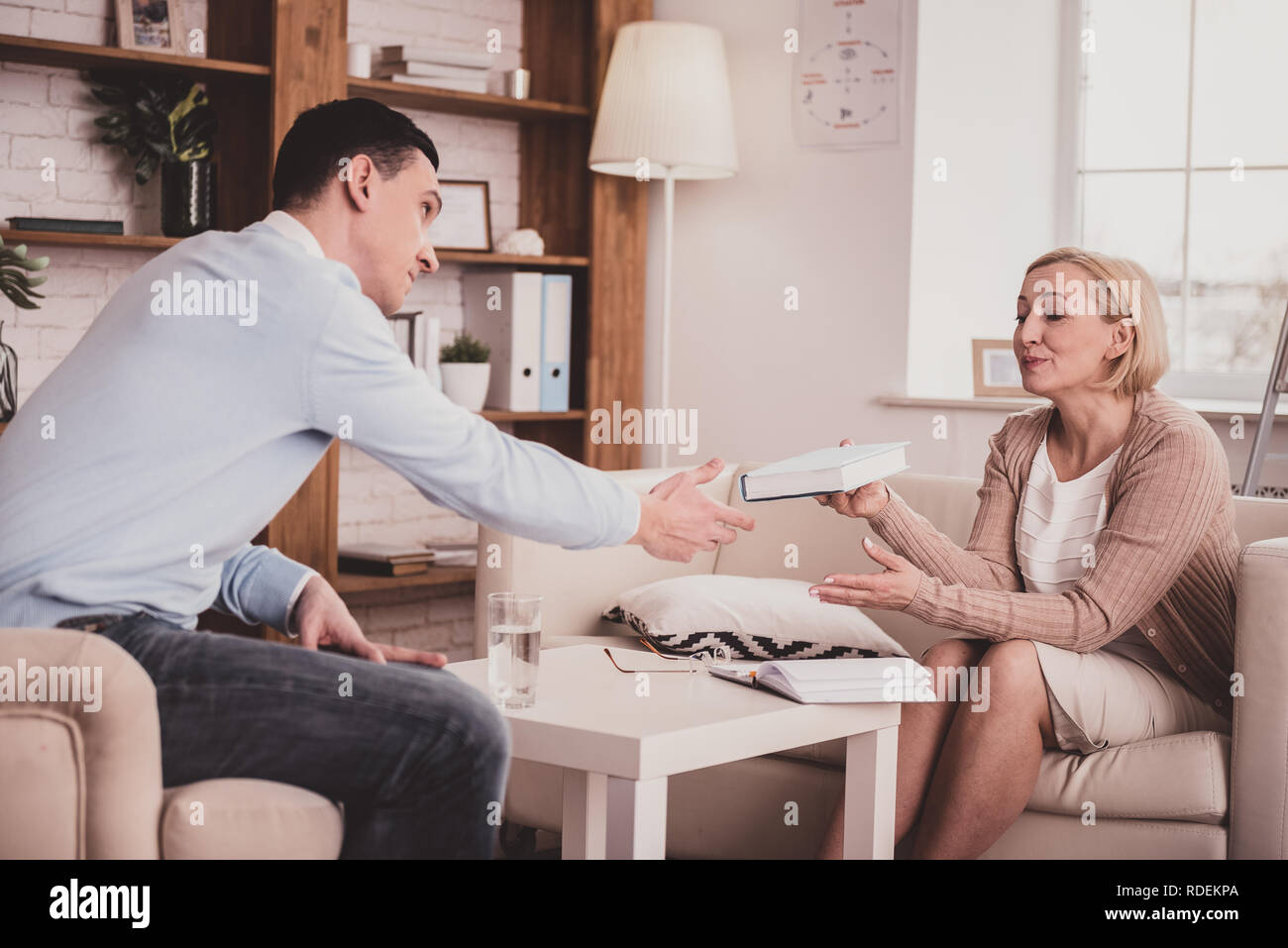 Pretty blonde female presenting her new book Stock Photo - Alamy