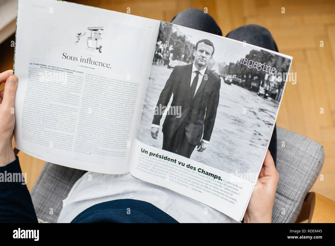 Paris, France - Jan 2, 2019: Woman reading article in M le magazine du ...