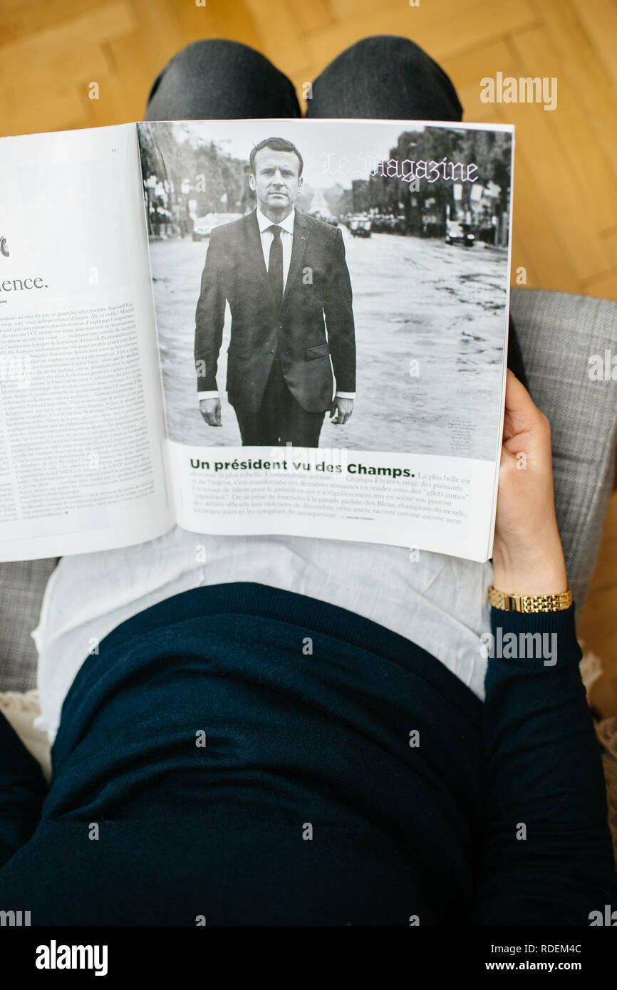Paris, France - Jan 2, 2019: Vertical image of woman reading article in ...