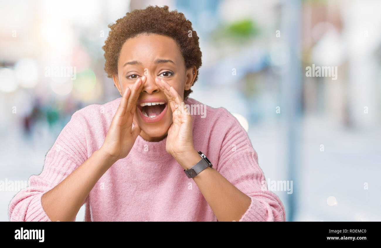 Beautiful young african american woman over isolated background ...
