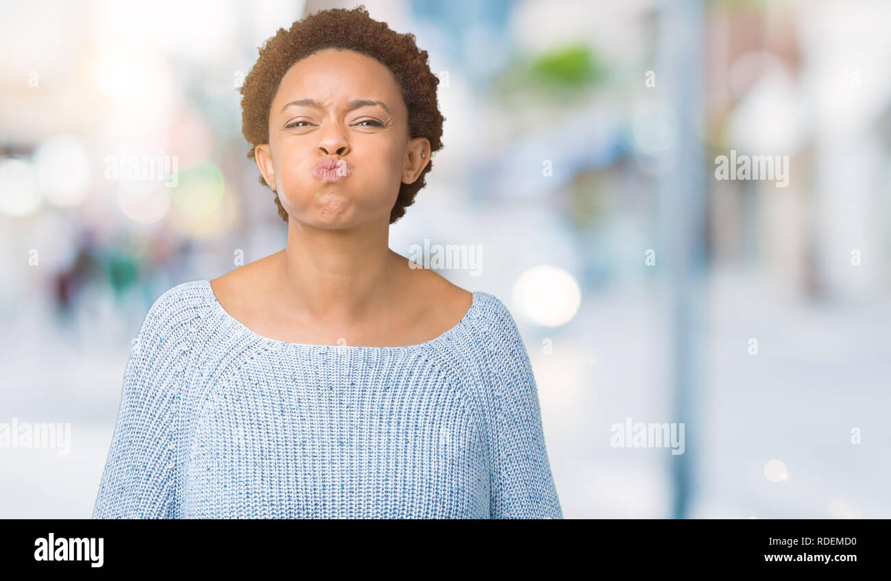 Young beautiful african american woman wearing a sweater over isolated ...