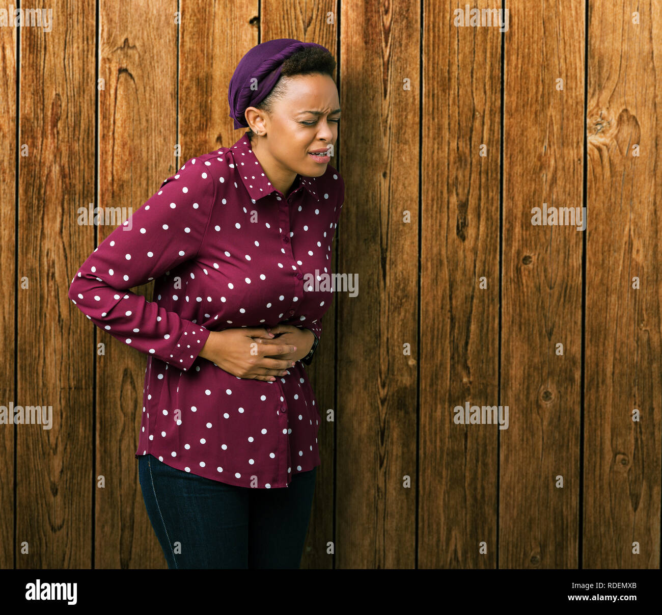 Beautiful young african american woman wearing head scarf over isolated ...